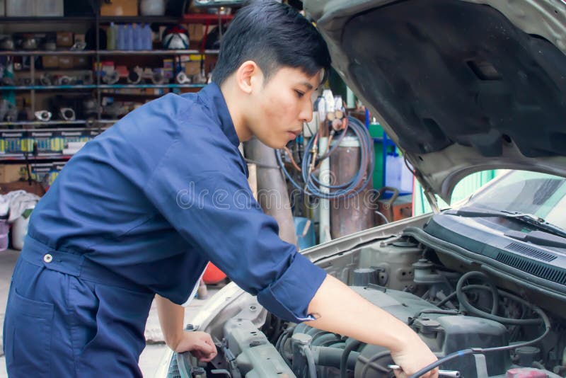A Man is Fixing Machine in Automotive Service Center Stock Image ...