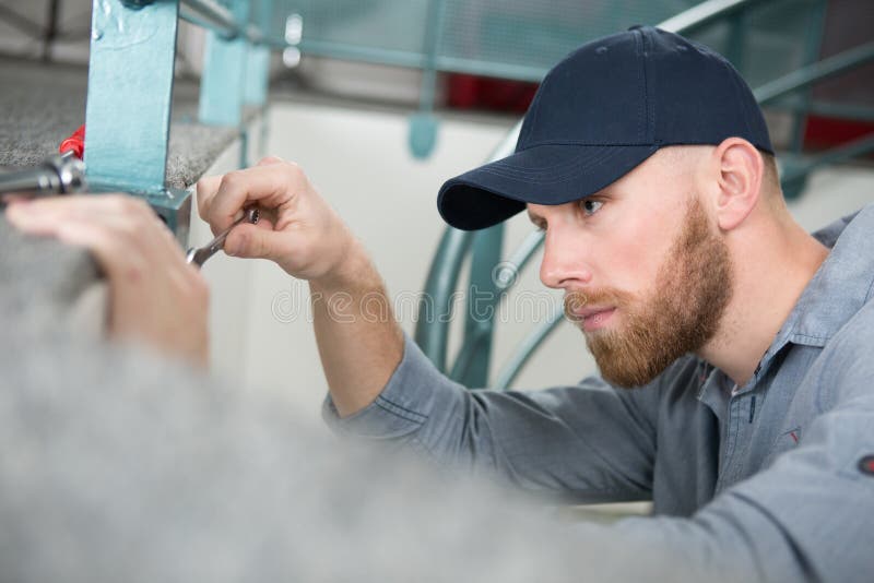 Man Fixing Machine in Factory Stock Image - Image of mechanician, metal ...