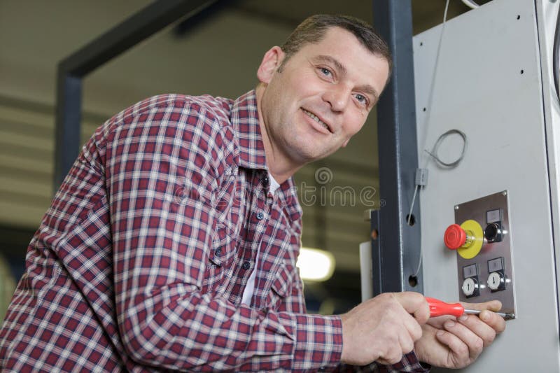 Man Fixing Machine in Factory Stock Photo - Image of professional, unit ...