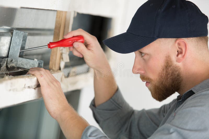 Man Fixing Metal Bracket To Wall Stock Photo - Image of fastener ...