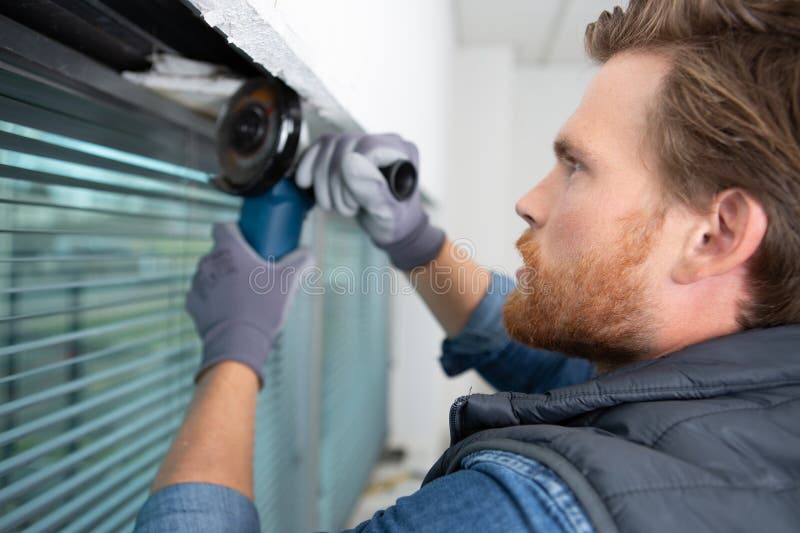 Man Fixing Metal Frame Using Angle Grinder on Windows Stock Photo ...