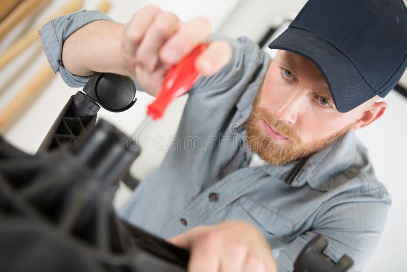 Man fixing office chair stock image. Image of ergonomic - 268744527