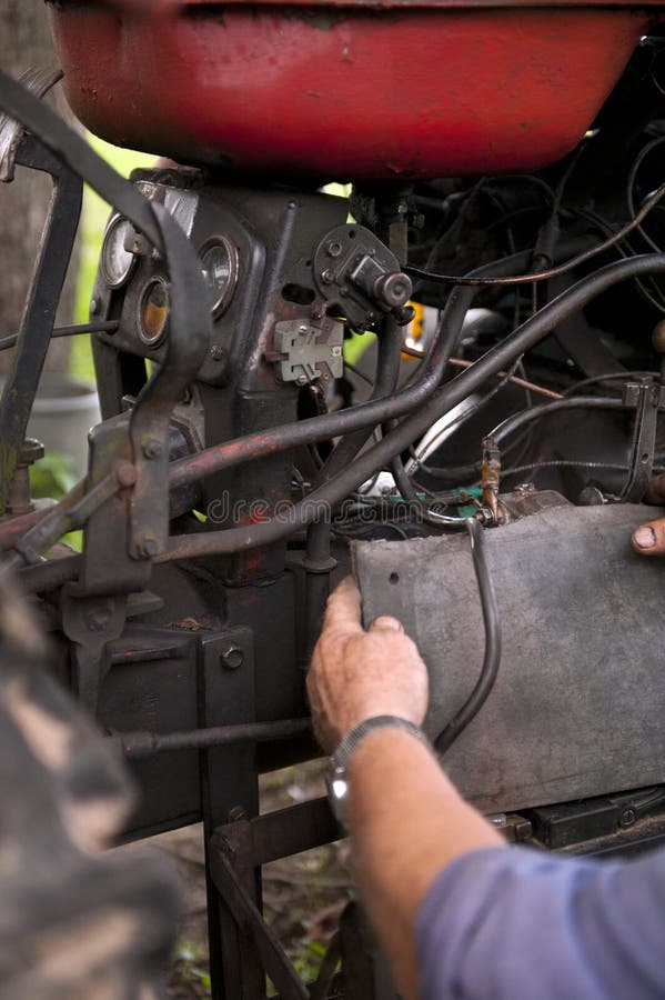 Man fixing old tractor stock photo. Image of automobile - 28536786