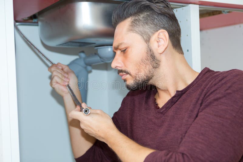 Man Fixing Pipes Under Sink Stock Image - Image of leaking, underground ...