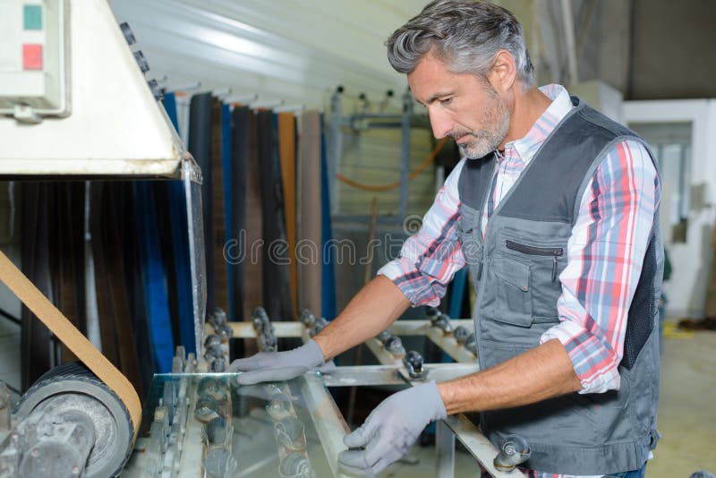 Man fixing roller machine stock photo. Image of company - 158693820