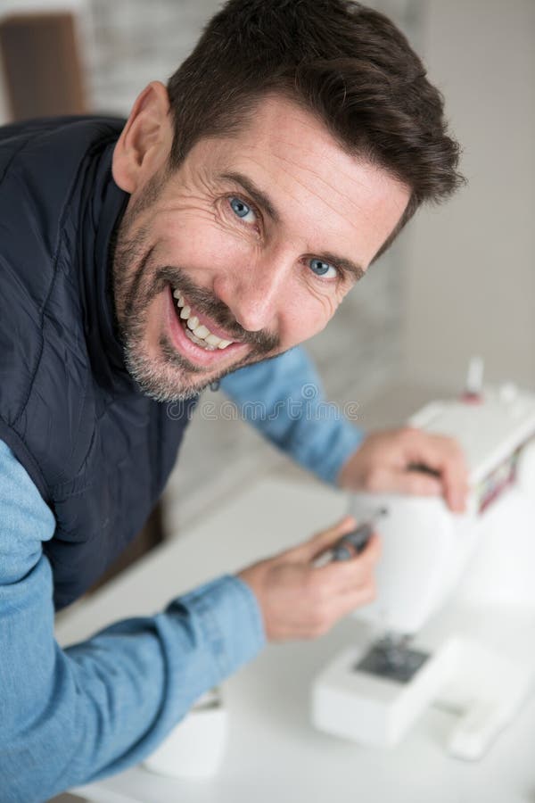Man fixing sewing machine stock image. Image of rough - 315449821