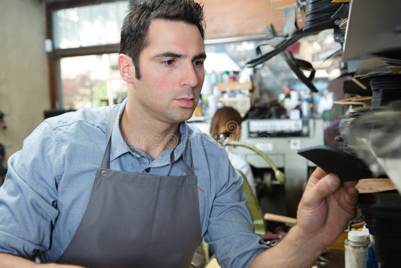 Man fixing shoes stock photo. Image of craft, shoes - 262493968