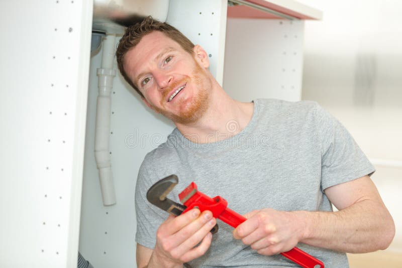 Man Fixing Sink Pipe in Kitchen Stock Image - Image of sink, pipewrench ...