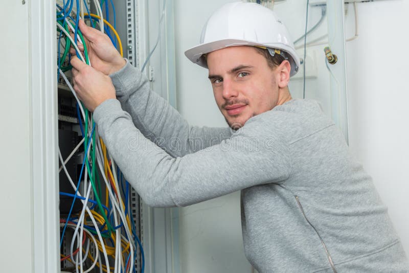 Man fixing tangled wires stock image. Image of electricity - 196684635