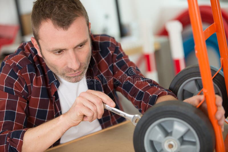 Man fixing trolley stock image. Image of transport, metal - 262850629
