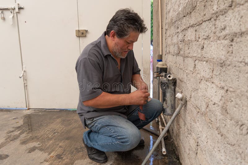 Man fixing a tube stock image. Image of building, mounter - 179993261