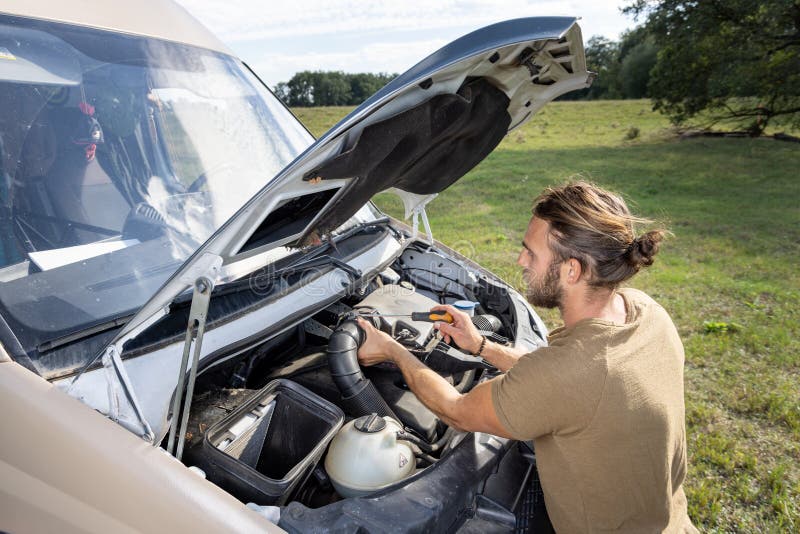 Man fixing a van outdoors stock image. Image of motor - 263327937