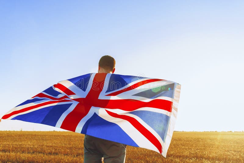 Man with a Flag of Great Britain Standing in Field Stock Image - Image ...