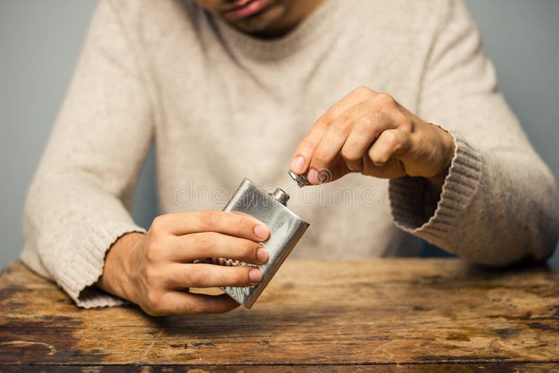 Man with flask at table stock photo. Image of foreground - 32990962