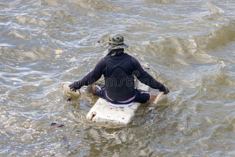 A Man Floating on a Polystyrene and Used a Lids for Paddled Stock Photo ...