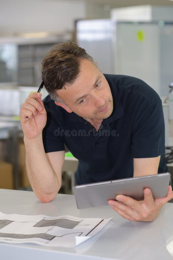 Man with floor plan design stock image. Image of business - 127757695
