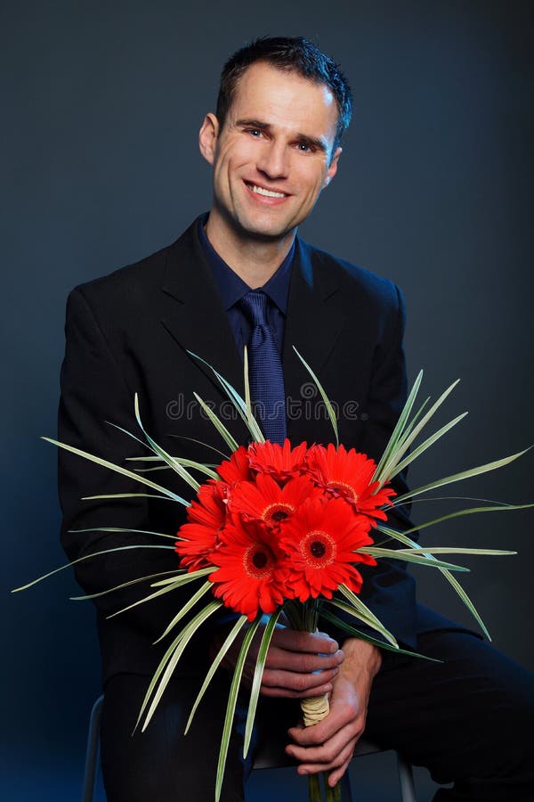 Man with Flowers of Gerberas Stock Photo - Image of handsome, flower ...