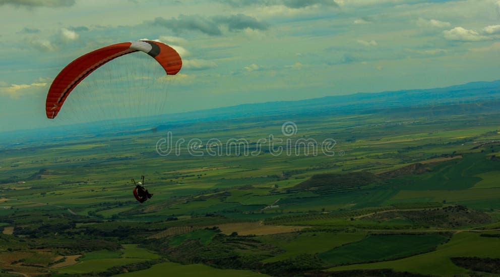 Man fly over the field stock image. Image of parachute - 92310779