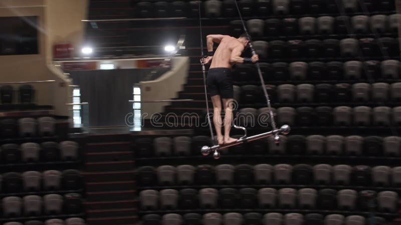 A Man Flying Around Upside Down on Performance on High at the Circus ...