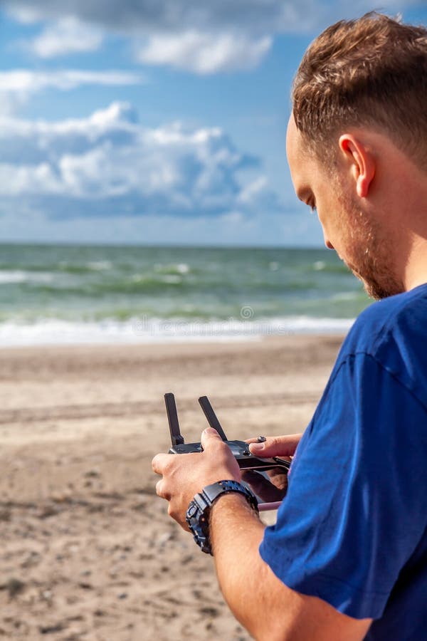 Man Flying His Drone by Using a Remote Controller on the Beach Stock ...