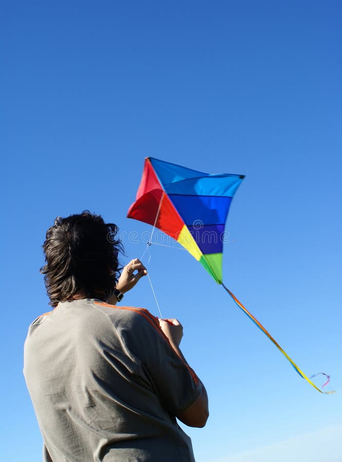 Man flying a kite stock image. Image of blue, colours - 10452665