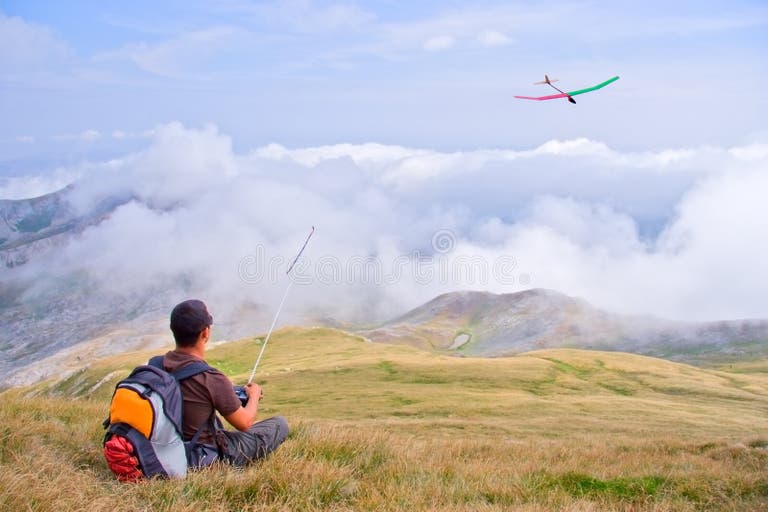 Man Flying a Plane from a Top of the Mountain Stock Image - Image of ...