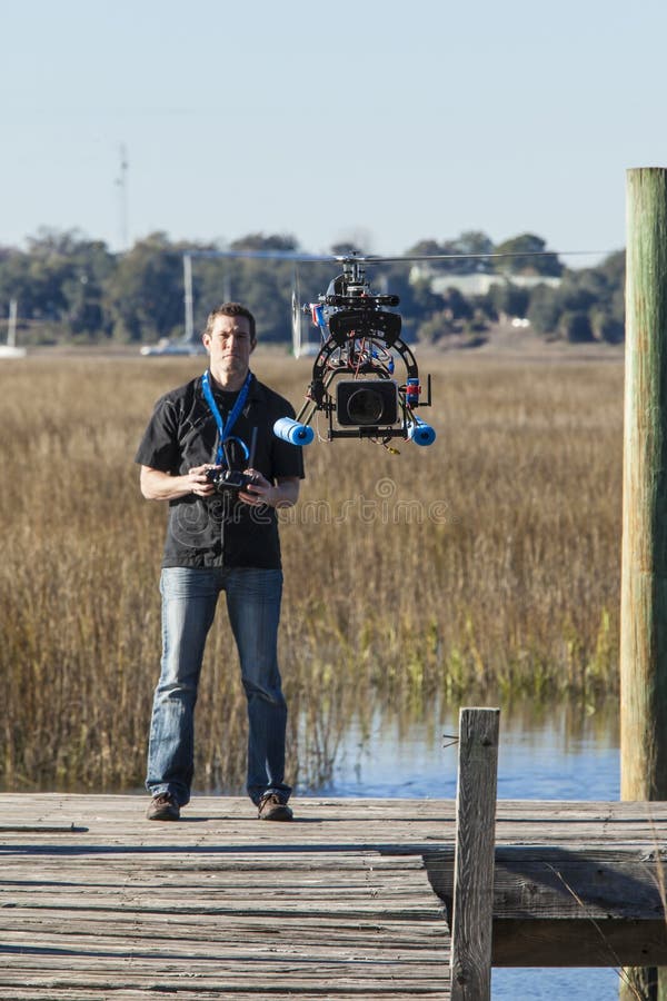 Man flying unmanned drone stock photo. Image of person - 40014436