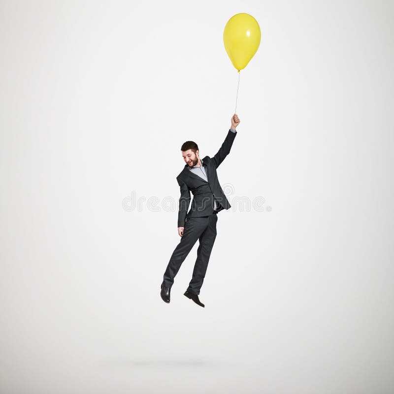 Man Flying with Yellow Balloon Stock Image - Image of worker, wear ...