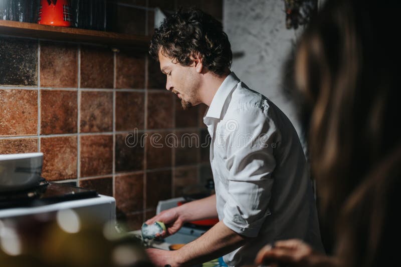 Man Focused on Cooking in a Rustic Kitchen Setting Stock Photo - Image ...