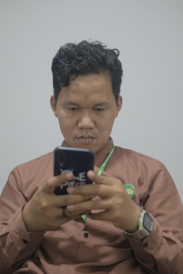 A Man is Focused on Playing with His Cellphone Stock Image - Image of ...