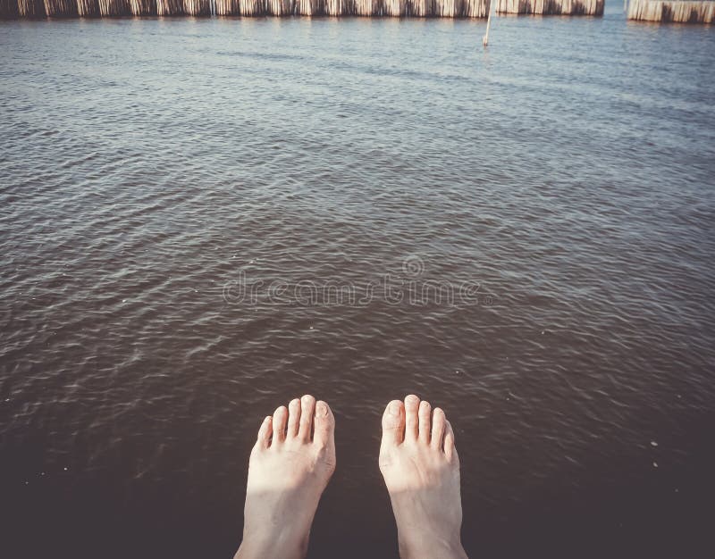 A Man Foot in the Stream Line of Deep Dark Water. Touching Nature Stock ...