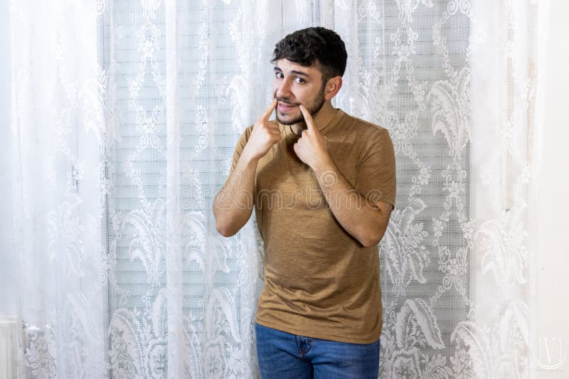 Man Forcing a Smile by Pointing at His Cheeks Stock Image - Image of ...