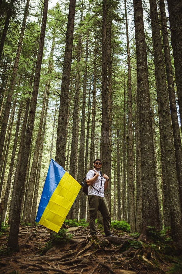 A Man in the Forest with a Ukrainian Flag Stock Photo - Image of ...