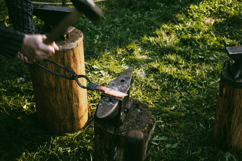 A Man Forging a Knife, Blacksmith S Workshop in the Open Air Stock ...