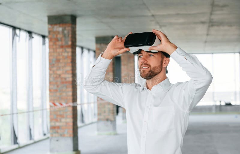 Man in Formal Clothes is Playing VR Game in the Building that are on ...
