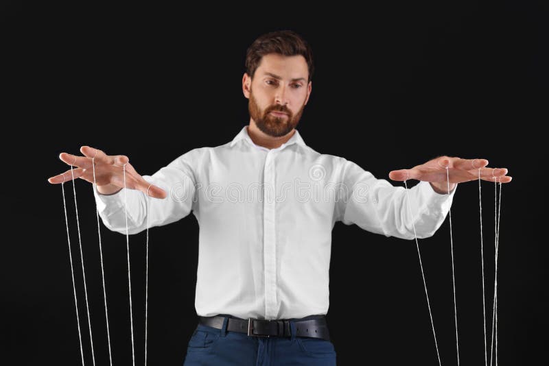 Man Pulling Strings of Puppet on White Background, Closeup Stock Photo ...