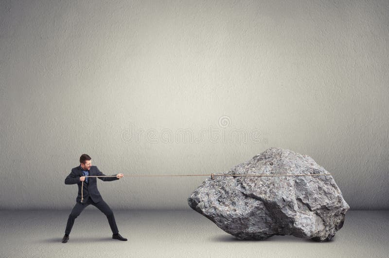 Man in Formal Wear Pulling the Big Stone Over Light Grey Background ...