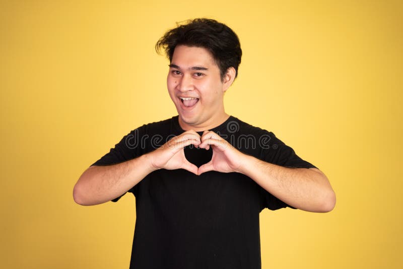 Man Forming a Heart with Finger Gestures on Isolated Background Stock ...