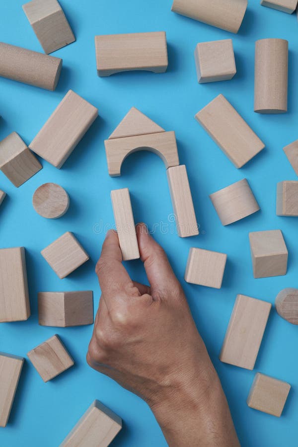 Man Forms a House with Building Blocks Stock Photo - Image of plaything ...