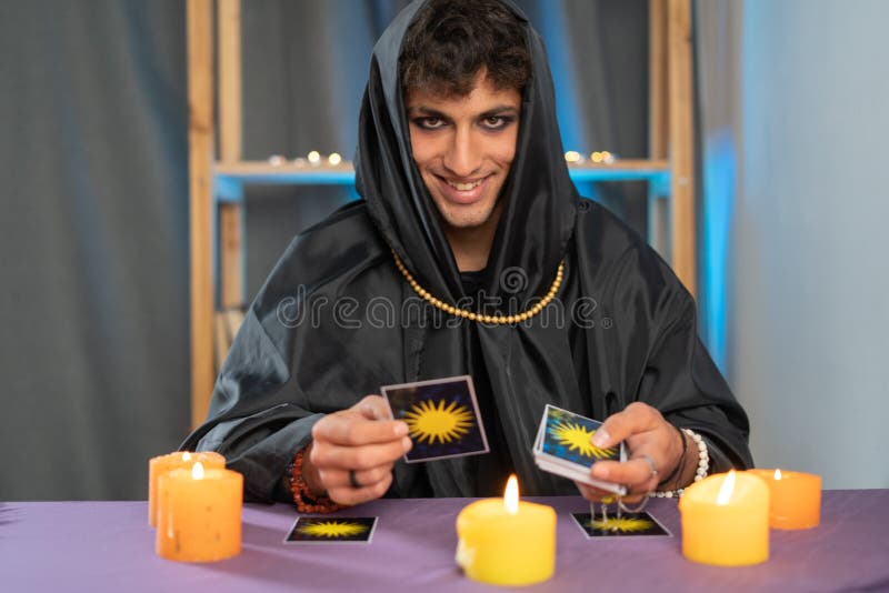 Man Fortune Teller Reading the Future by Tarot Cards Sitting at a Table ...