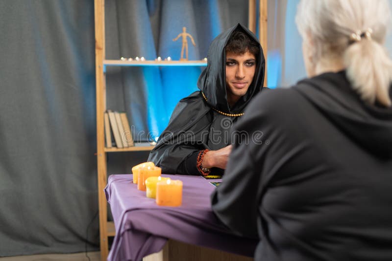 Man Fortune Teller is Reading Tarot Cards for Client. Stock Image ...