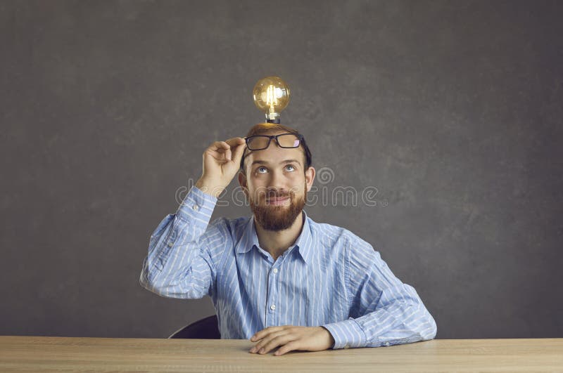 Man Freelancer with Light Bulb Over Head Sitting at Table Share Bright ...