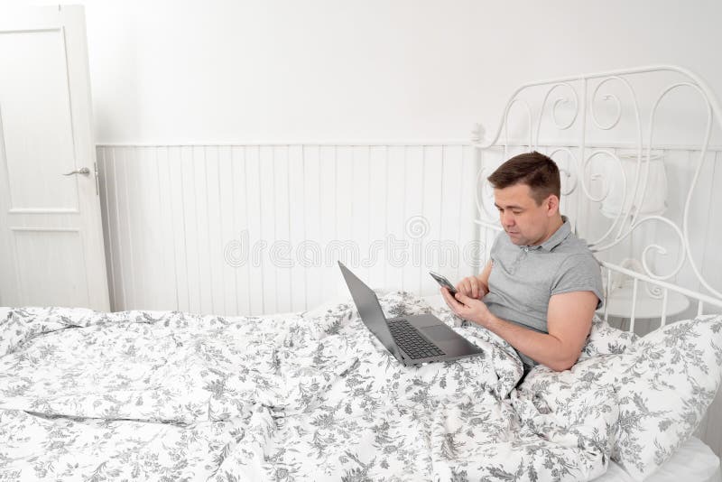Man Freelancer Texting on Phone in Bed Isolation Stock Photo - Image of ...