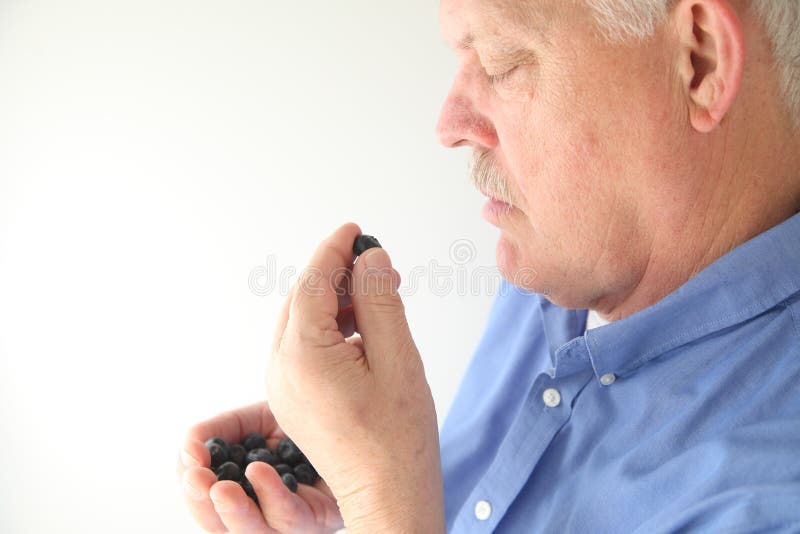 Man with fresh blueberries stock image. Image of head - 30362279