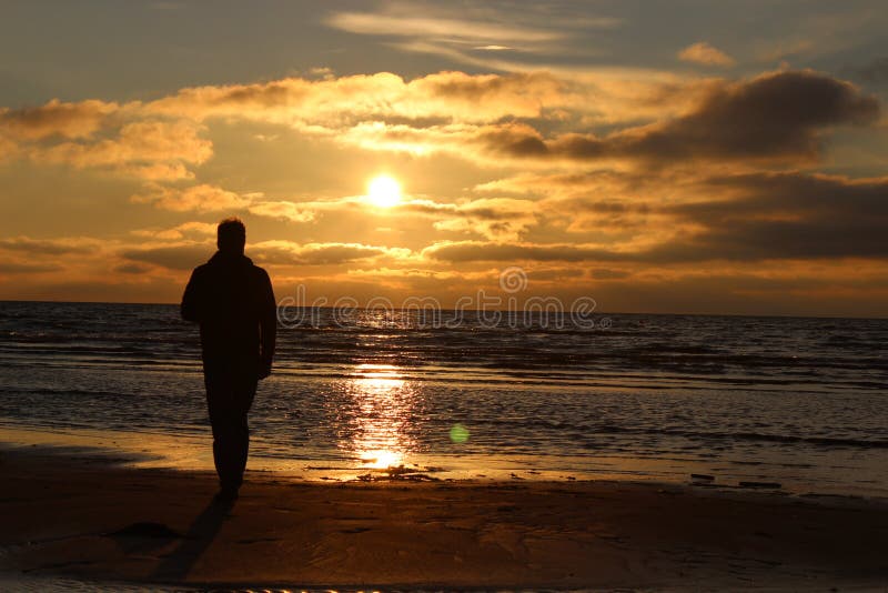 Man in front of sea sunset stock photo. Image of coast - 45201502
