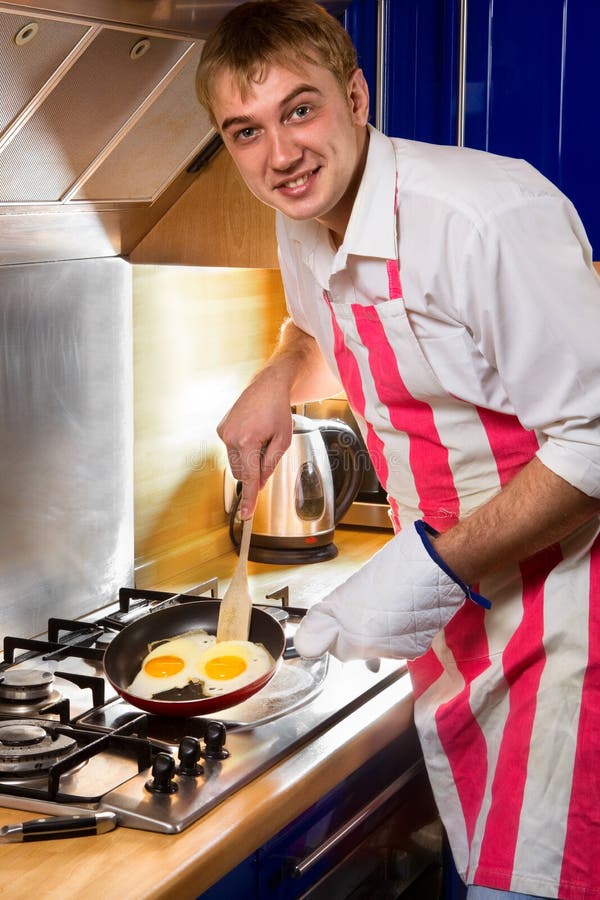 Man frying eggs stock photo. Image of stove, preparation - 23660832