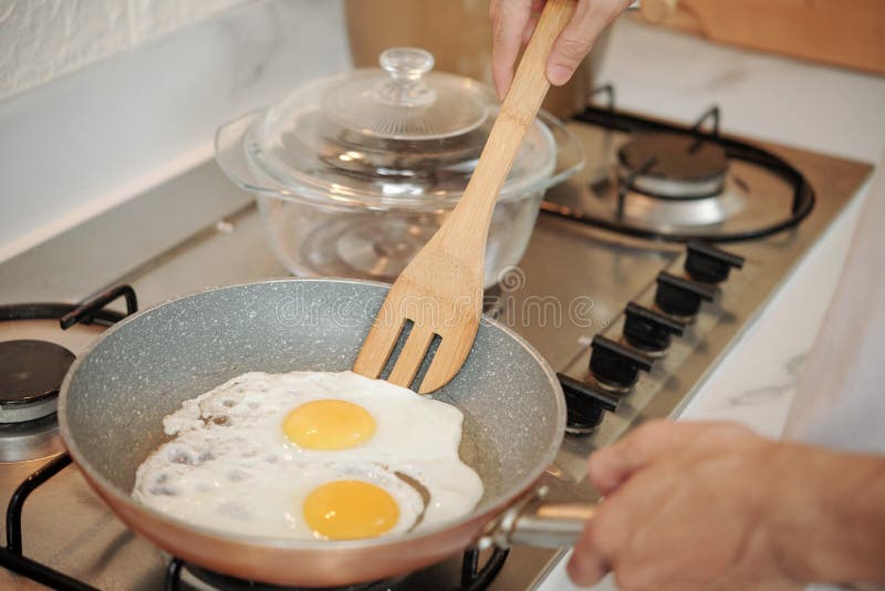 Man Frying Eggs stock image. Image of kitchen, meal - 227548391