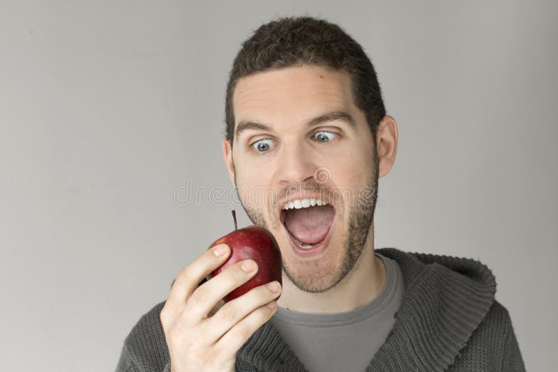 Man with Funny Face Looking at an Apple Stock Image - Image of funny ...