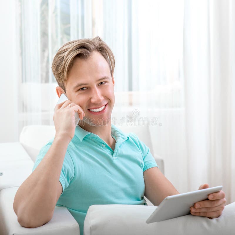 Man with Gadget Sitting at Home Stock Image - Image of indoors, couch ...