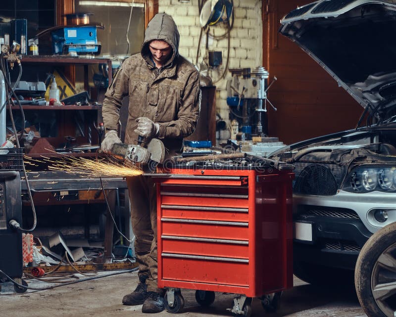 A man in a garage. stock image. Image of metal, blade - 108373189